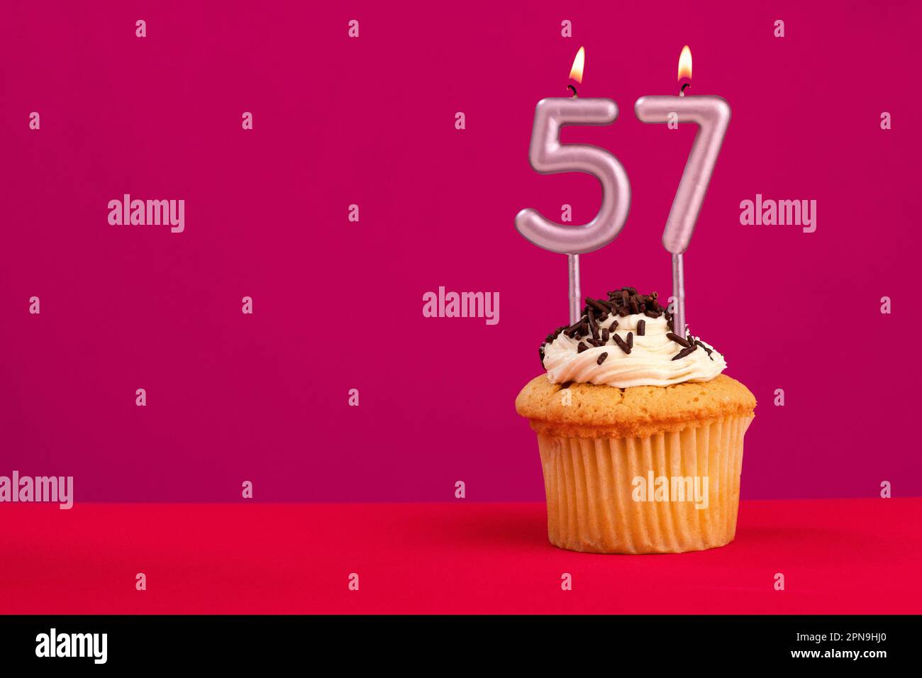 Birthday cake with candle number 57 - Rhodamine Red foamy background ...
