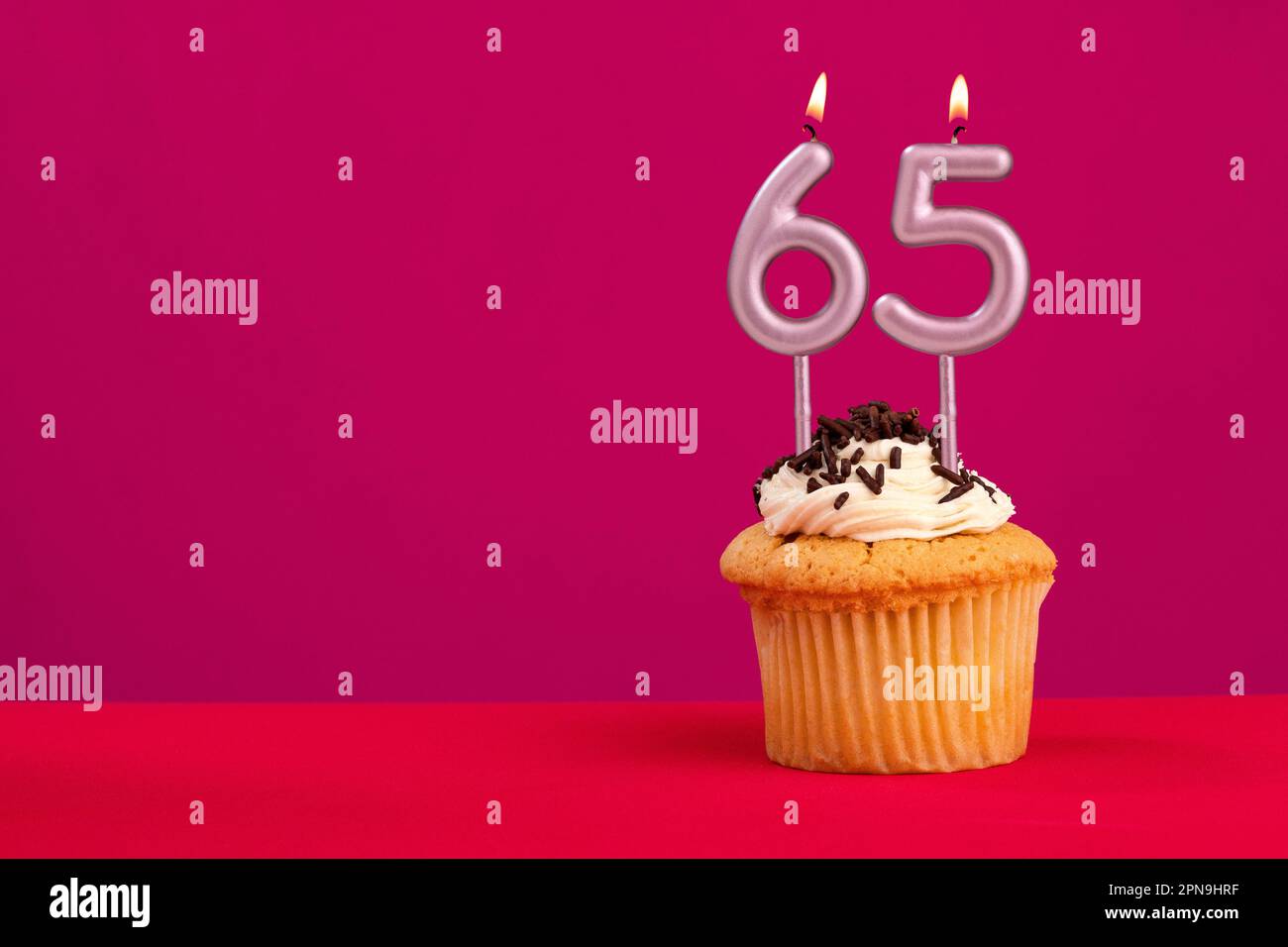 Birthday cake with candle number 65 - Rhodamine Red foamy background ...