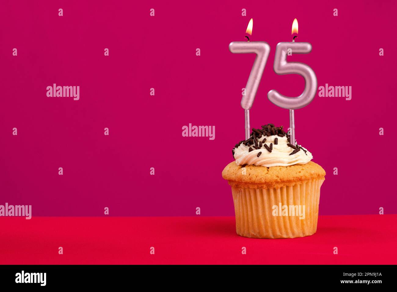 Birthday cake with candle number 75 - Rhodamine Red foamy background ...