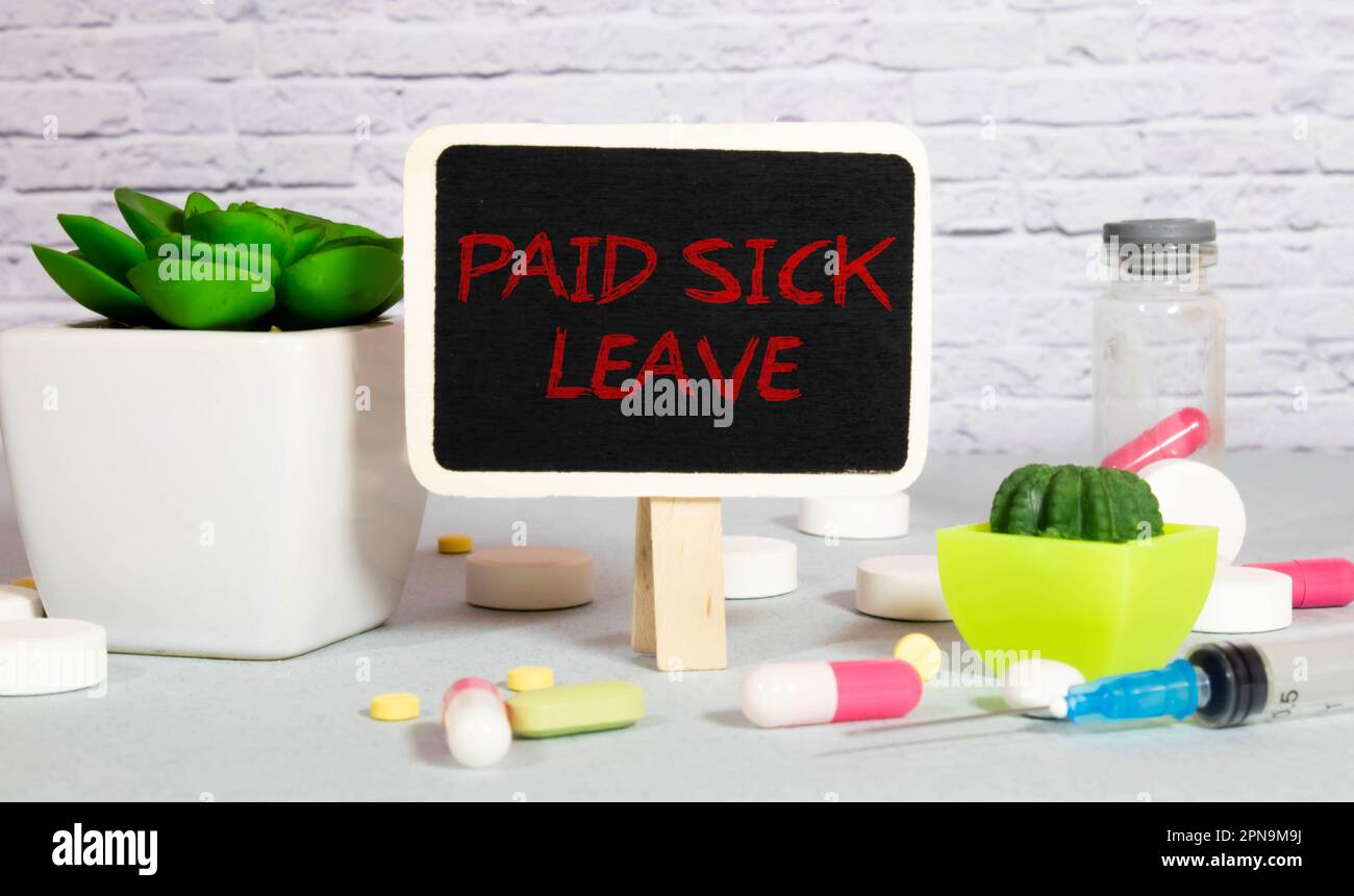 medical mask with the inscription paid sick leave Stock Photo - Alamy