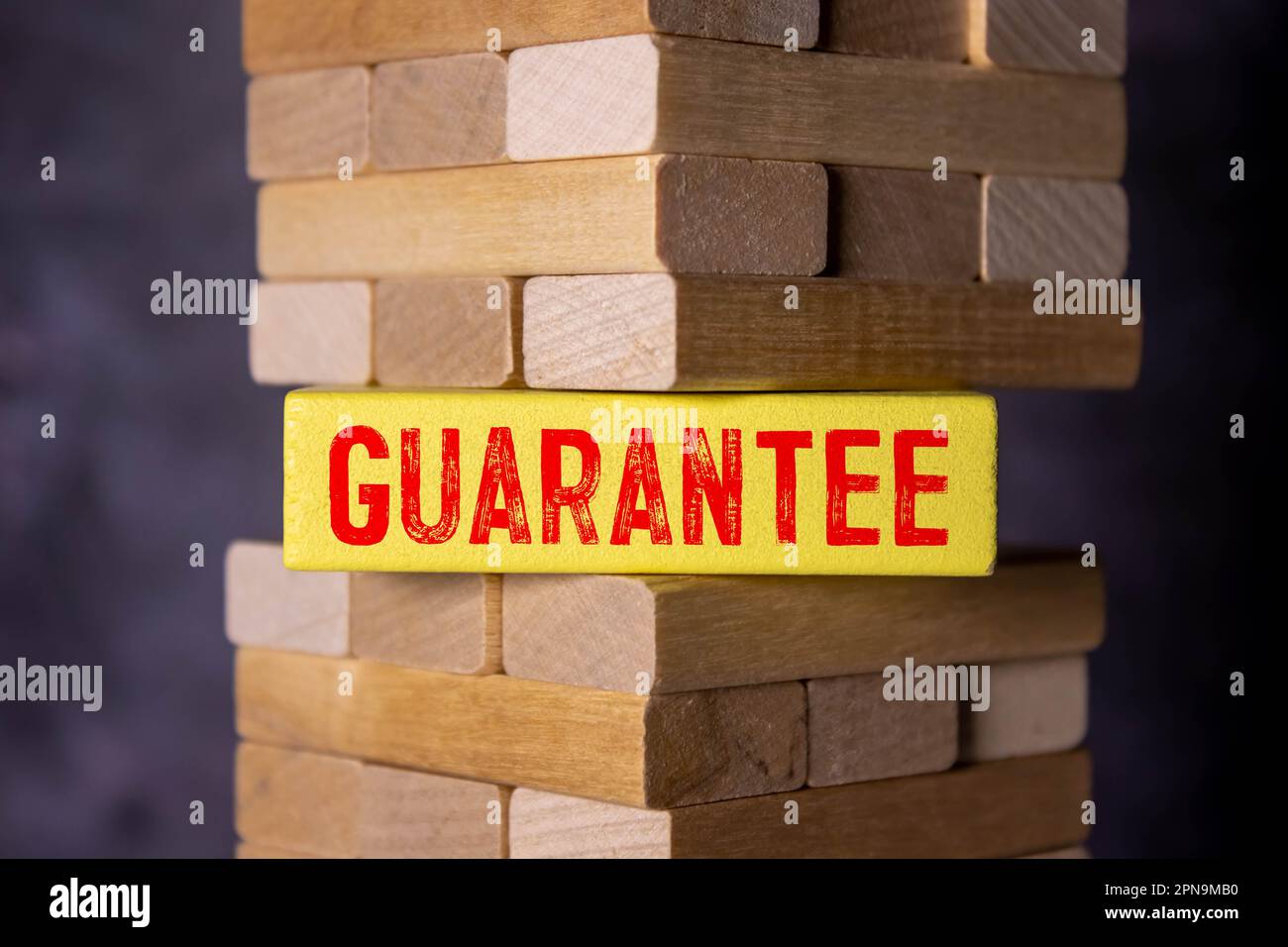 Text GUARANTEE on wood cube block, stock investment concept. The text ...