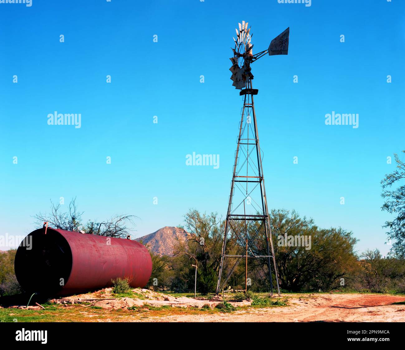 Windmill and storage in the Arizona desert Stock Photo - Alamy