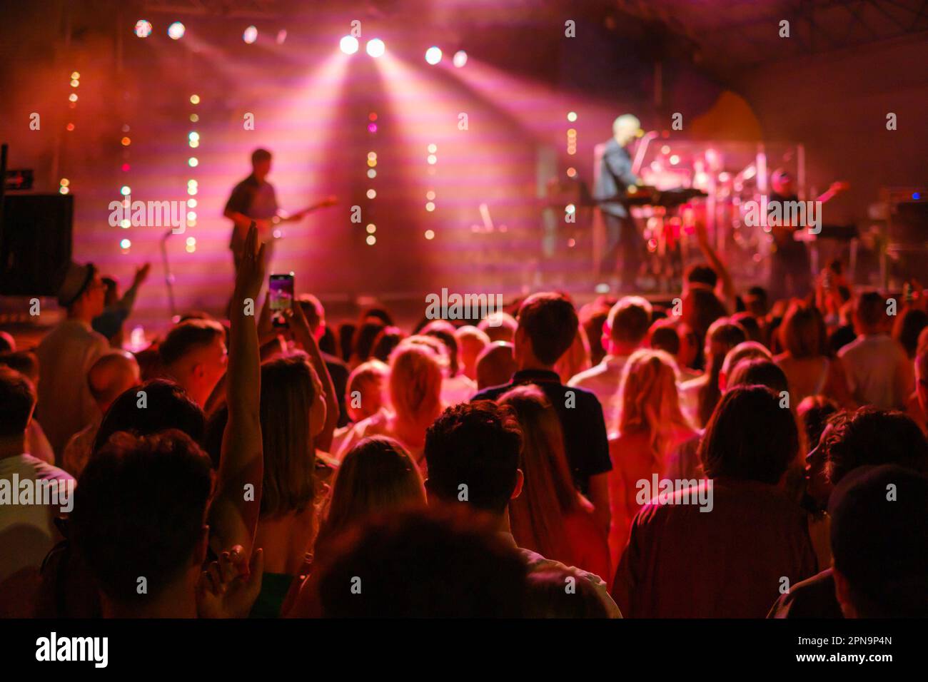 People gathering near stage during concert Stock Photo - Alamy