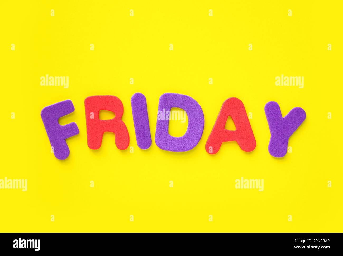 Friday word formed with colorful letters on yellow background with copy ...