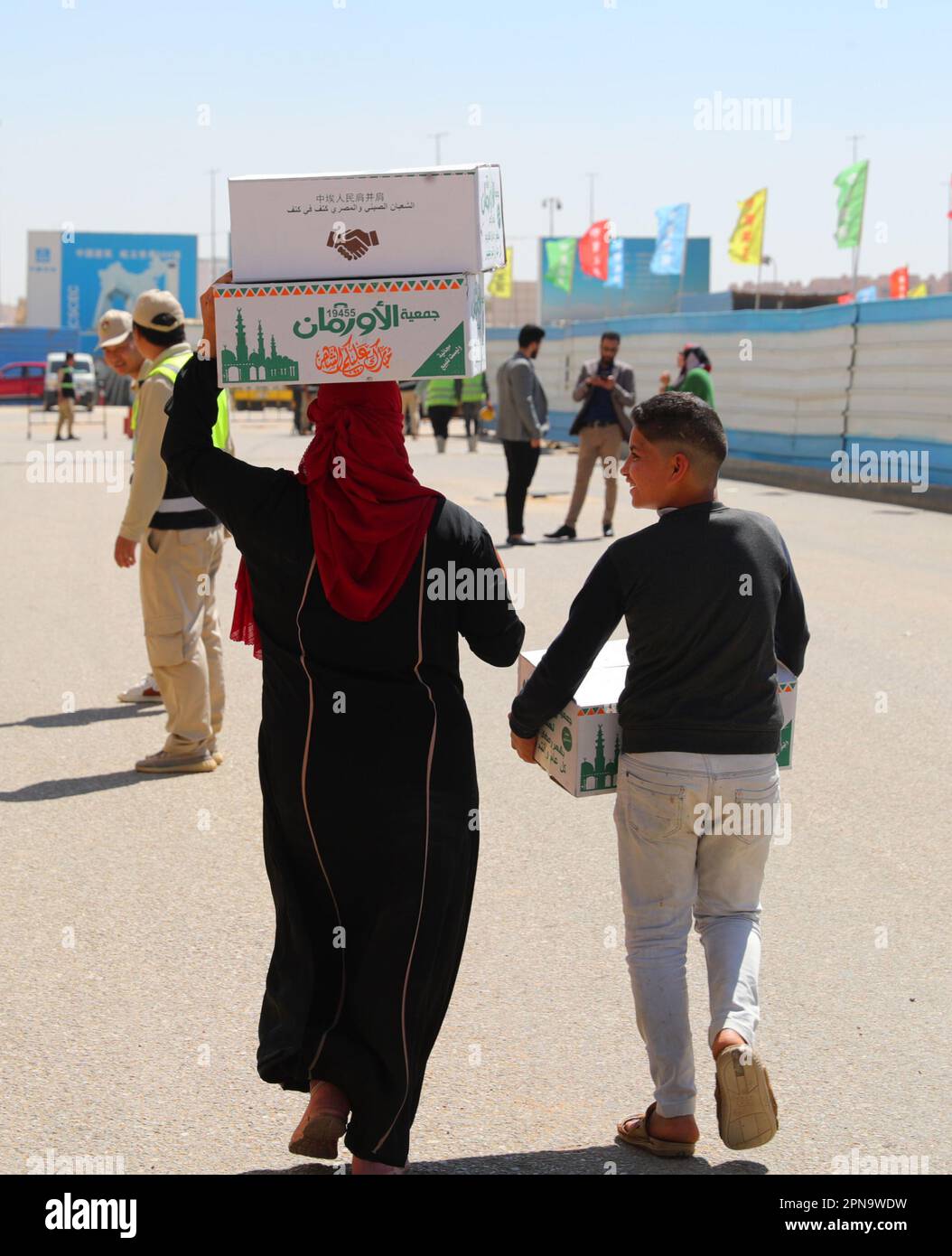 Cairo, Egypt. 16th Apr, 2023. People carry boxes of donated food during ...