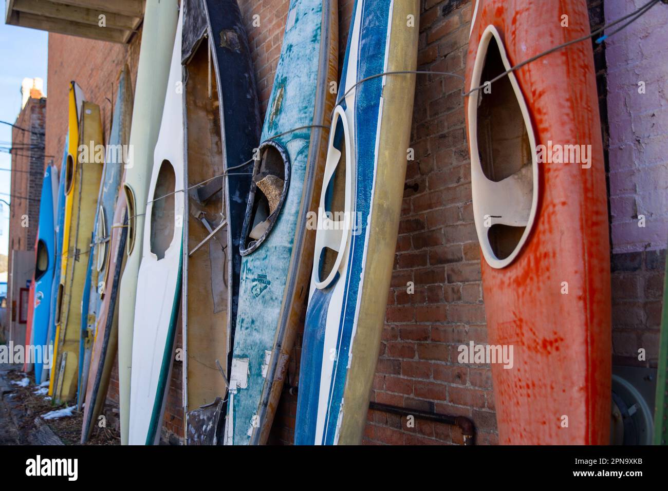 Canoes tied up in a row shot vertical Stock Photo - Alamy