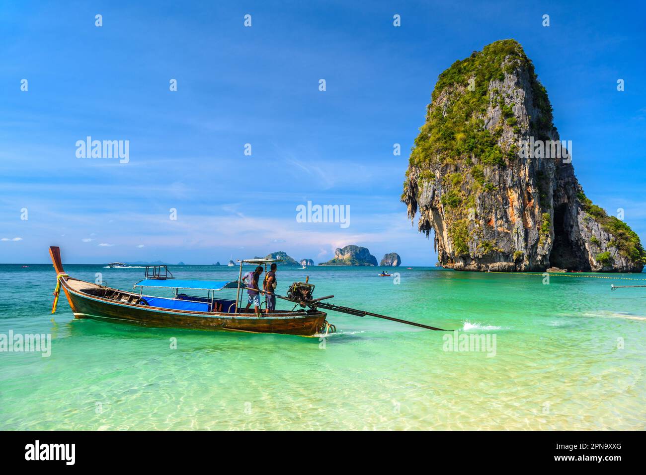 Long tail boats and cliff rock in azure water, Ko Rang Nok, Ao Phra ...