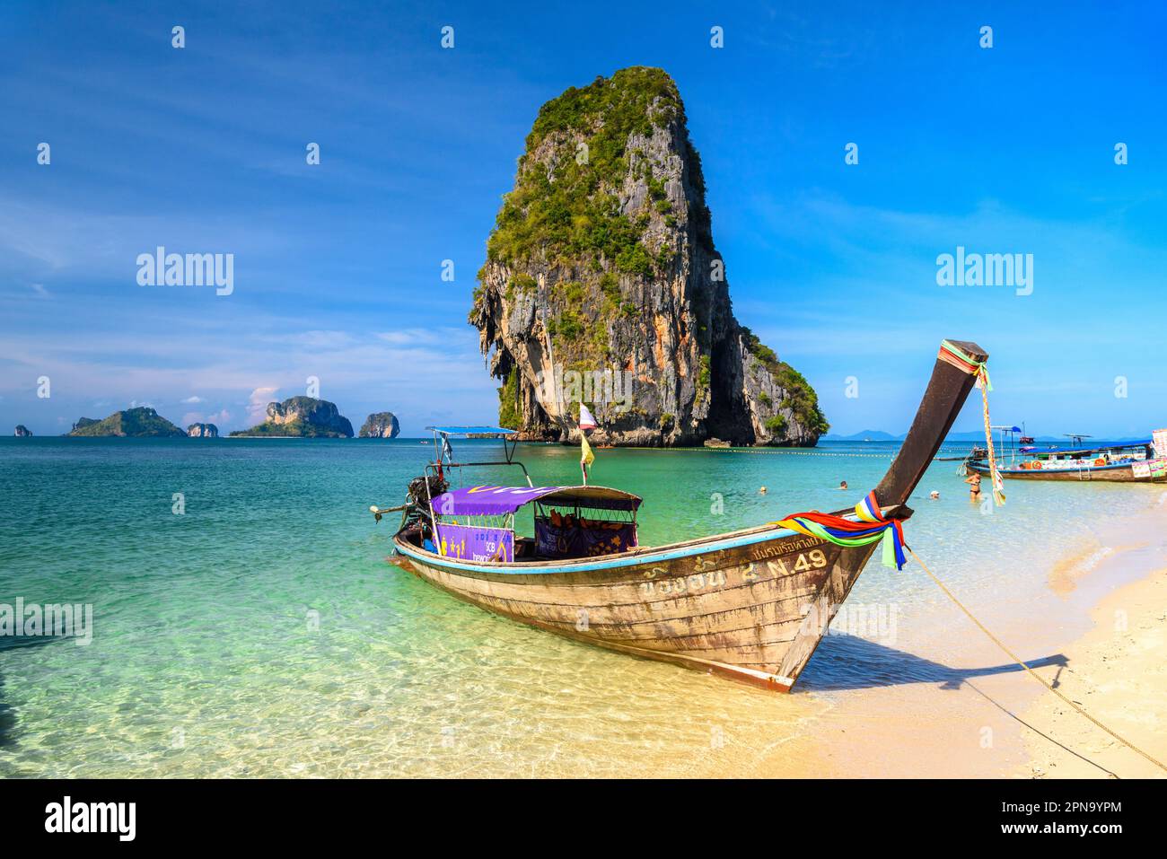 KRABI, THAILAND- MARCH 2018: Long tail boats and cliff rock in azure ...