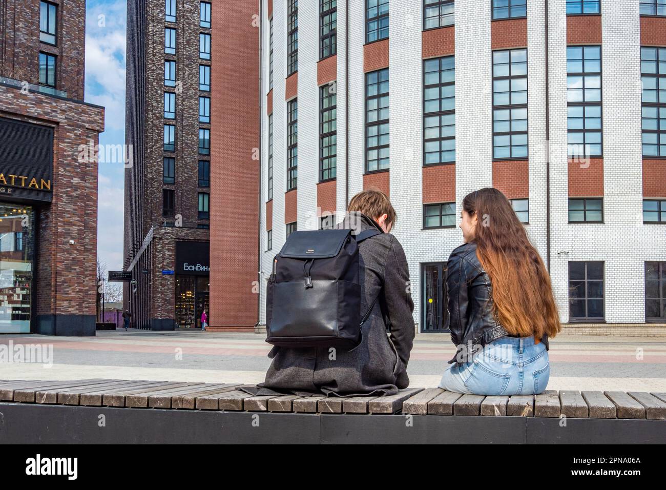 Russia, Moscow. A man and a woman sit on a bench in a city street Stock ...