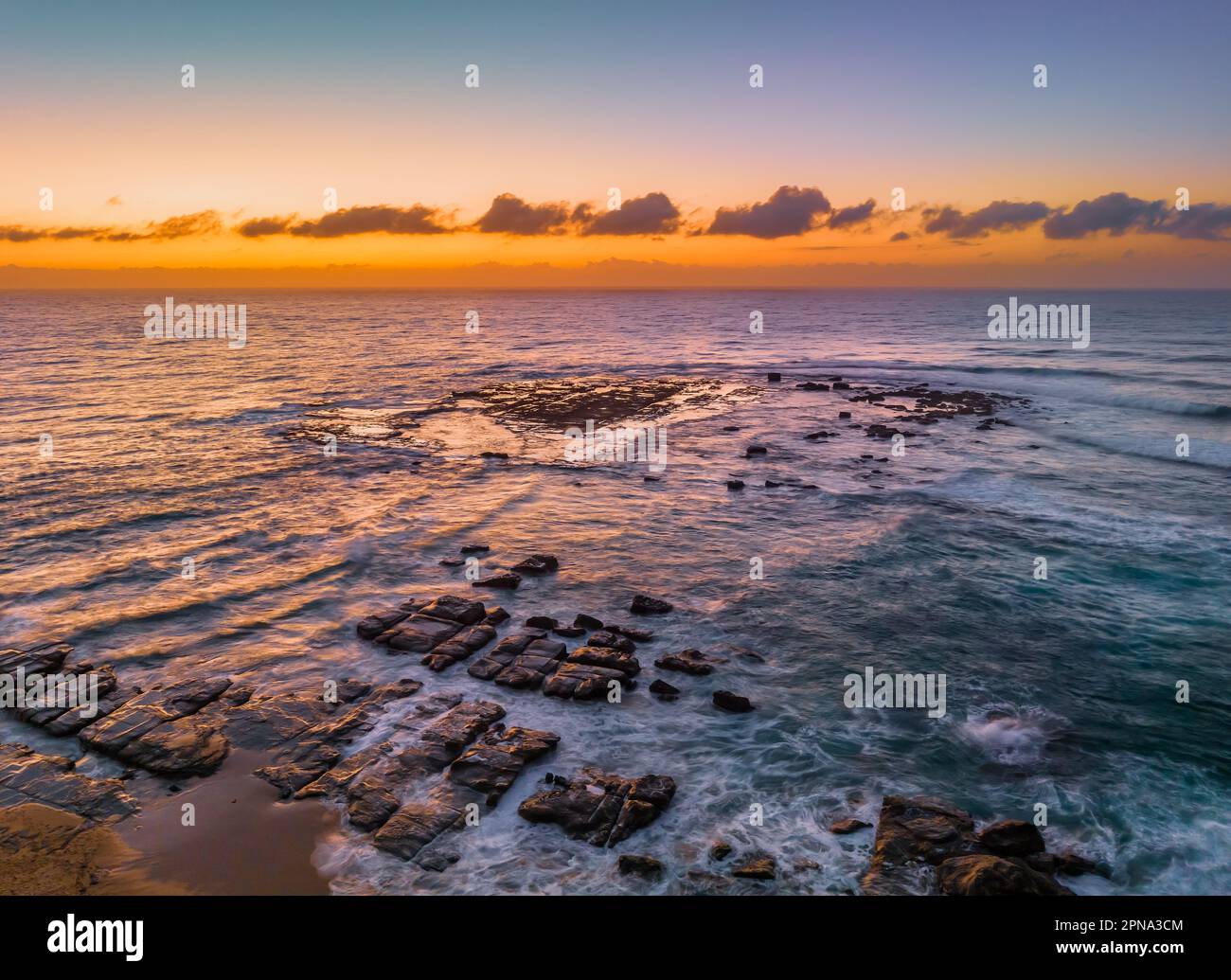 Sunrise seascape with clouds at Soldiers Beach located at Norah Head on ...