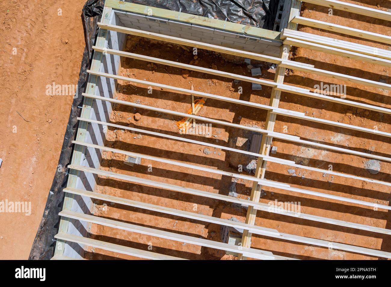 New custom home installation of wood floor joists trusses on concrete ...