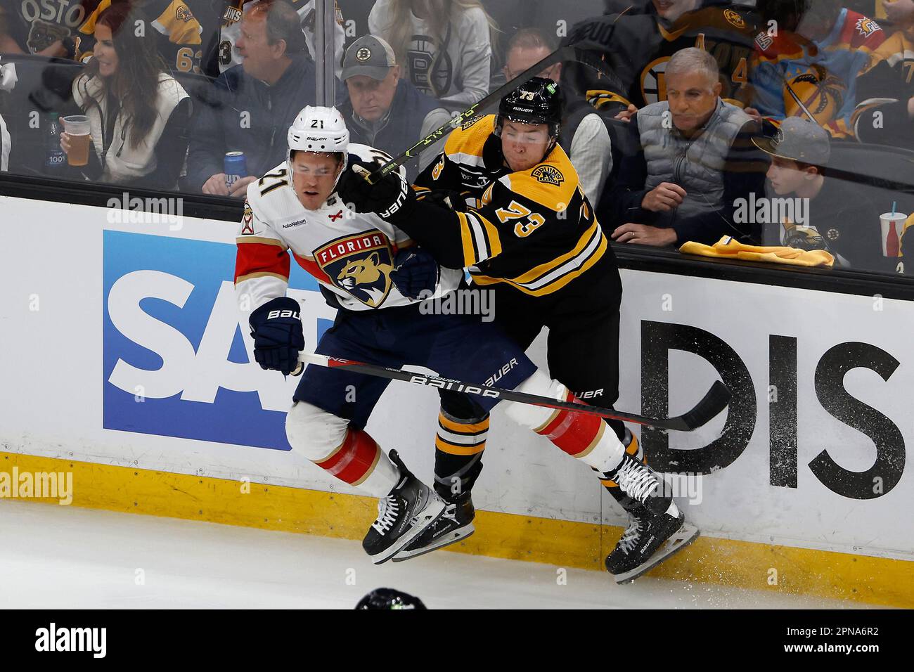 Boston Bruins defenseman Charlie McAvoy (73) checks Florida Panthers ...