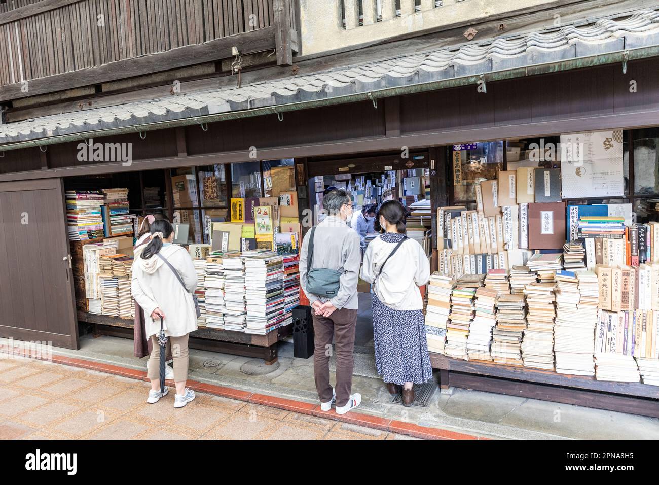 April 2023, traditional bookstore shop in Kyoto selling vintage and rare books, customers browse ...