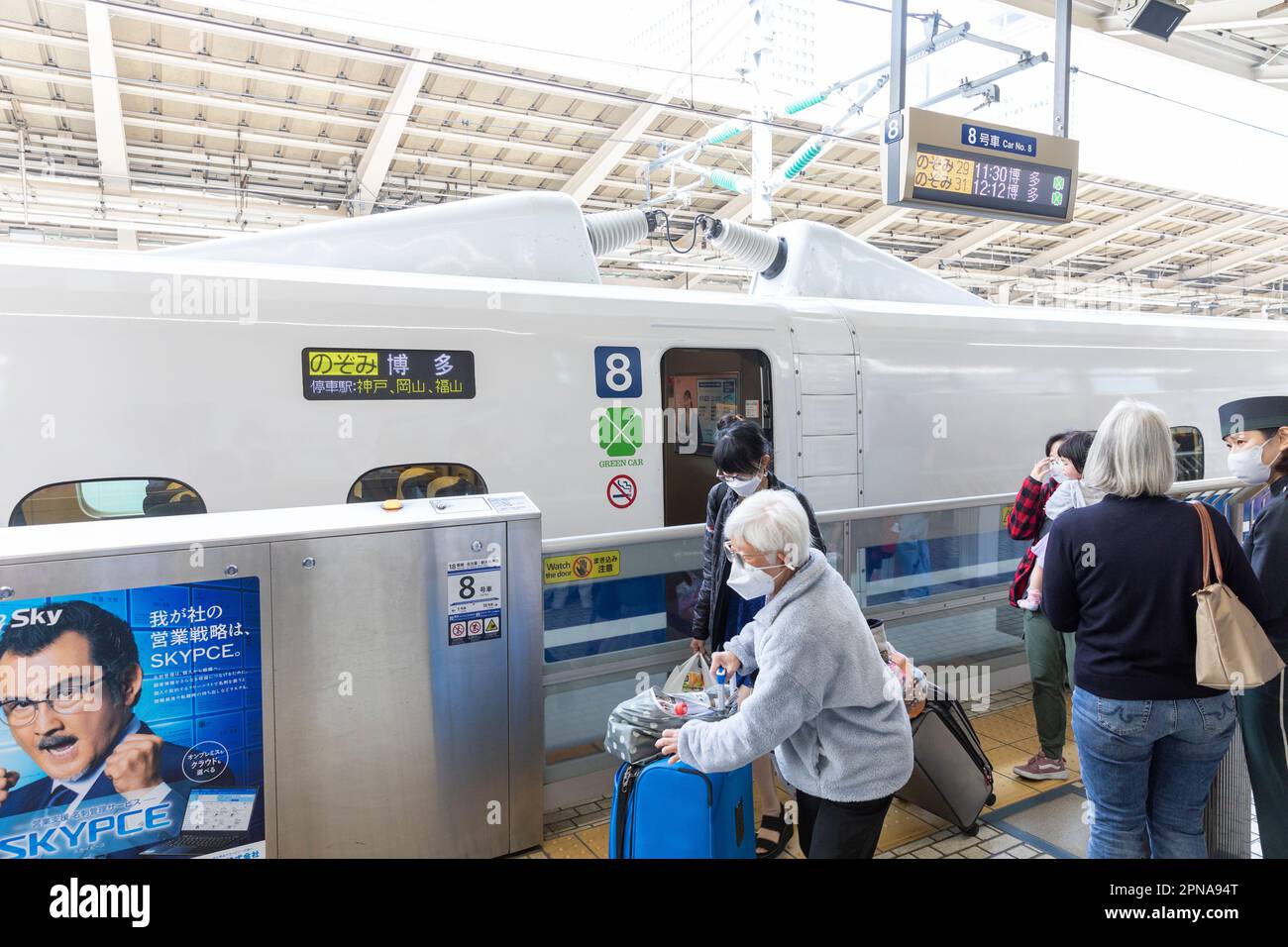 April 2023, passengers wait to board the green carriage car 8 of the bullet train Shinkansen at ...