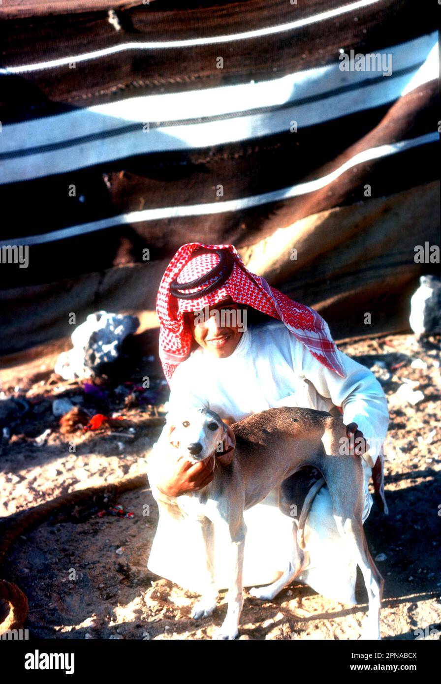 Bedouin boy outside family tent with saluqi dog in Kuwait, 1976 Stock ...