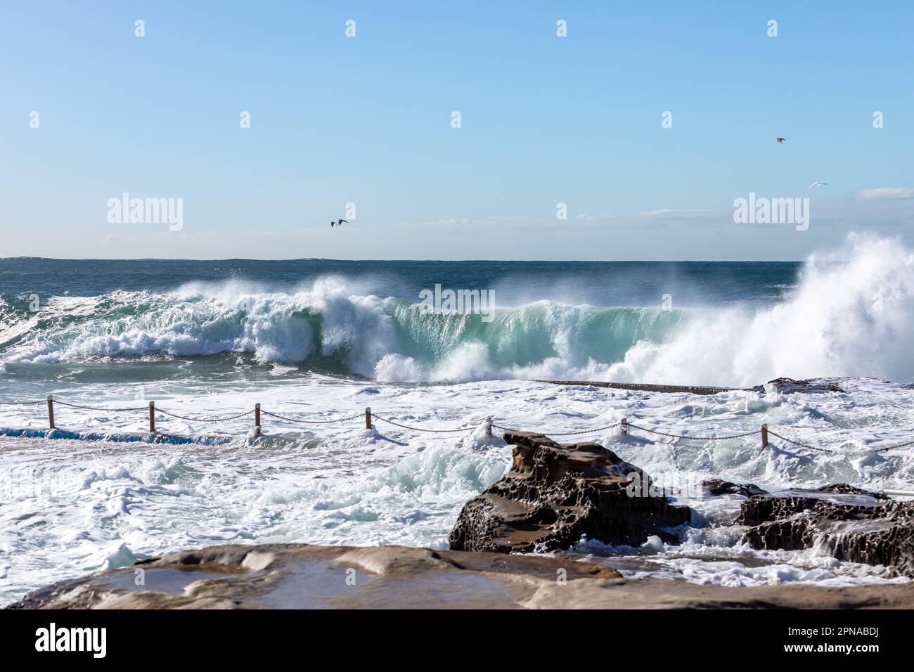 Waves crashing over Dee Why Beach Rockpools, ocean swimming pools Stock ...