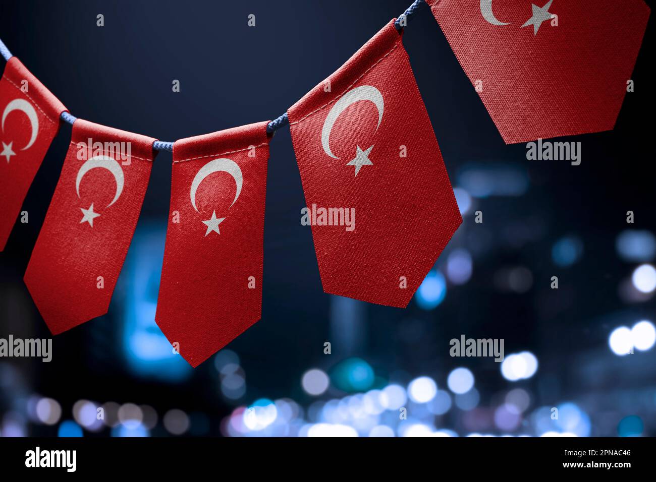 A garland of Turkey national flags on an abstract blurred background ...