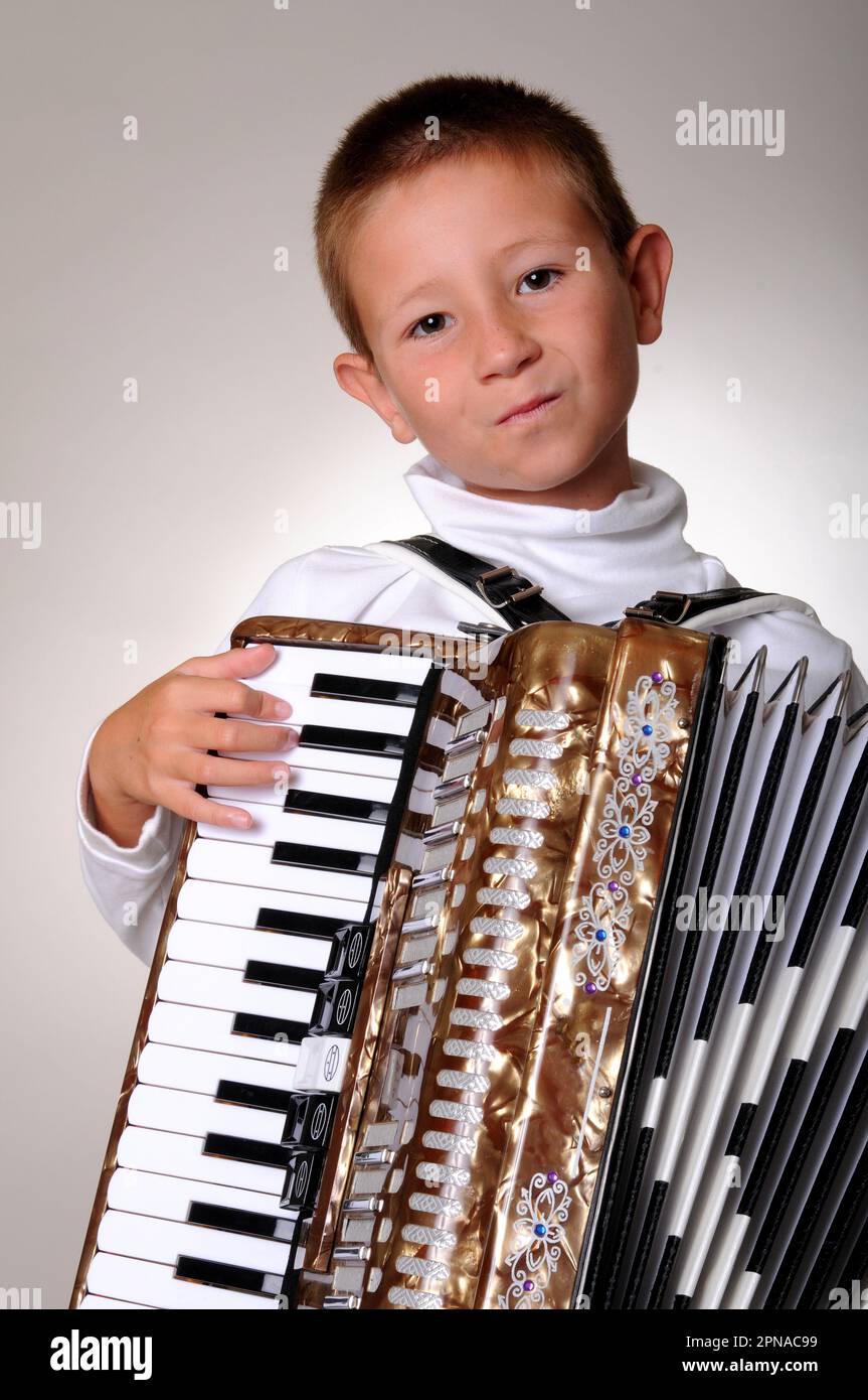 Young boy playing a 48 base accordion Stock Photo - Alamy
