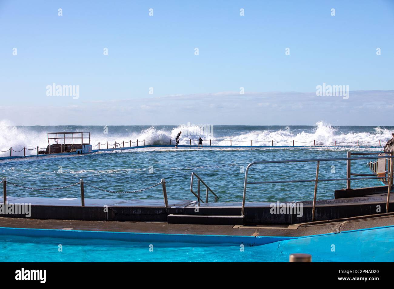 Waves crashing over Dee Why Beach Rockpools, ocean swimming pools. Two ...