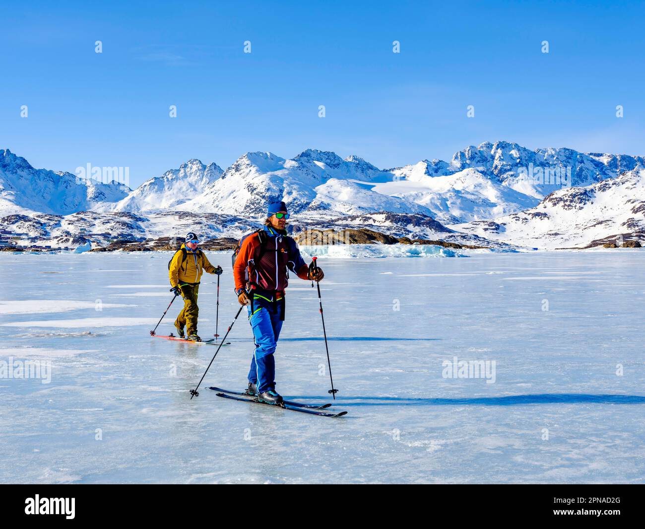 Ski mountaineers cross the frozen Kong Oscar Fjord, Tasiilaq ...