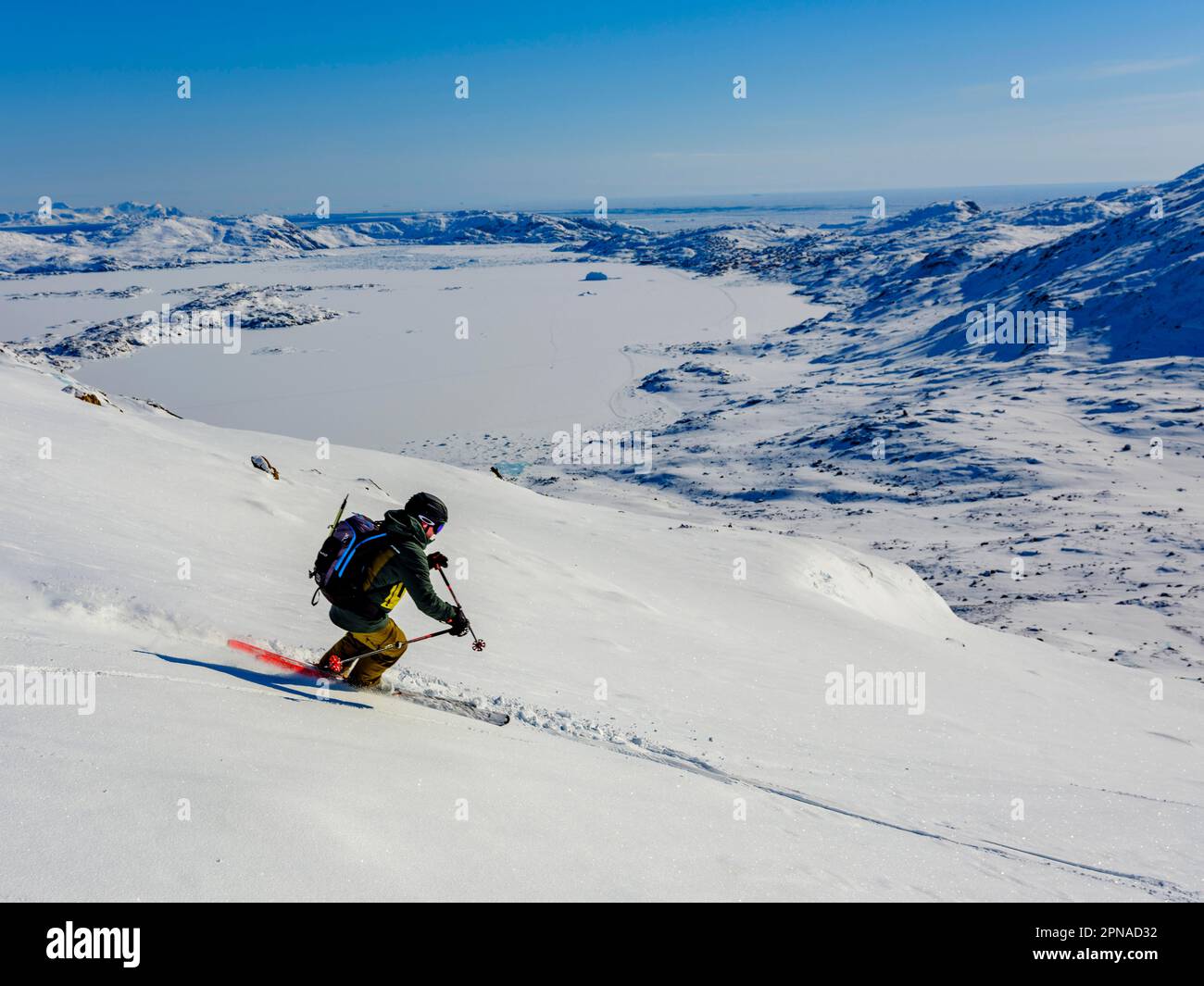 Ski mountaineers on the descent, the frozen Kong Oscar Fjord behind ...