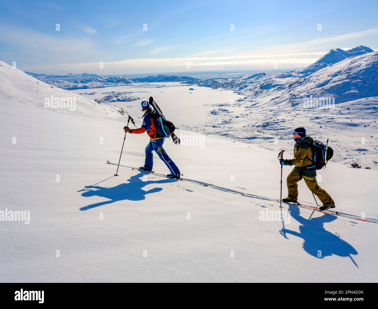 Ski mountaineer on ski tour, frozen Kong Oskar Fjord behind, Tasiilaq ...