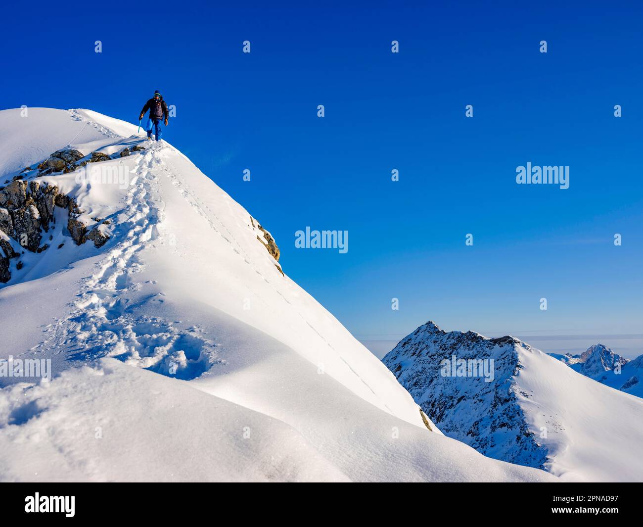 Climbers descending the snow ridge, Tasiilaq, Ammassalik Island ...