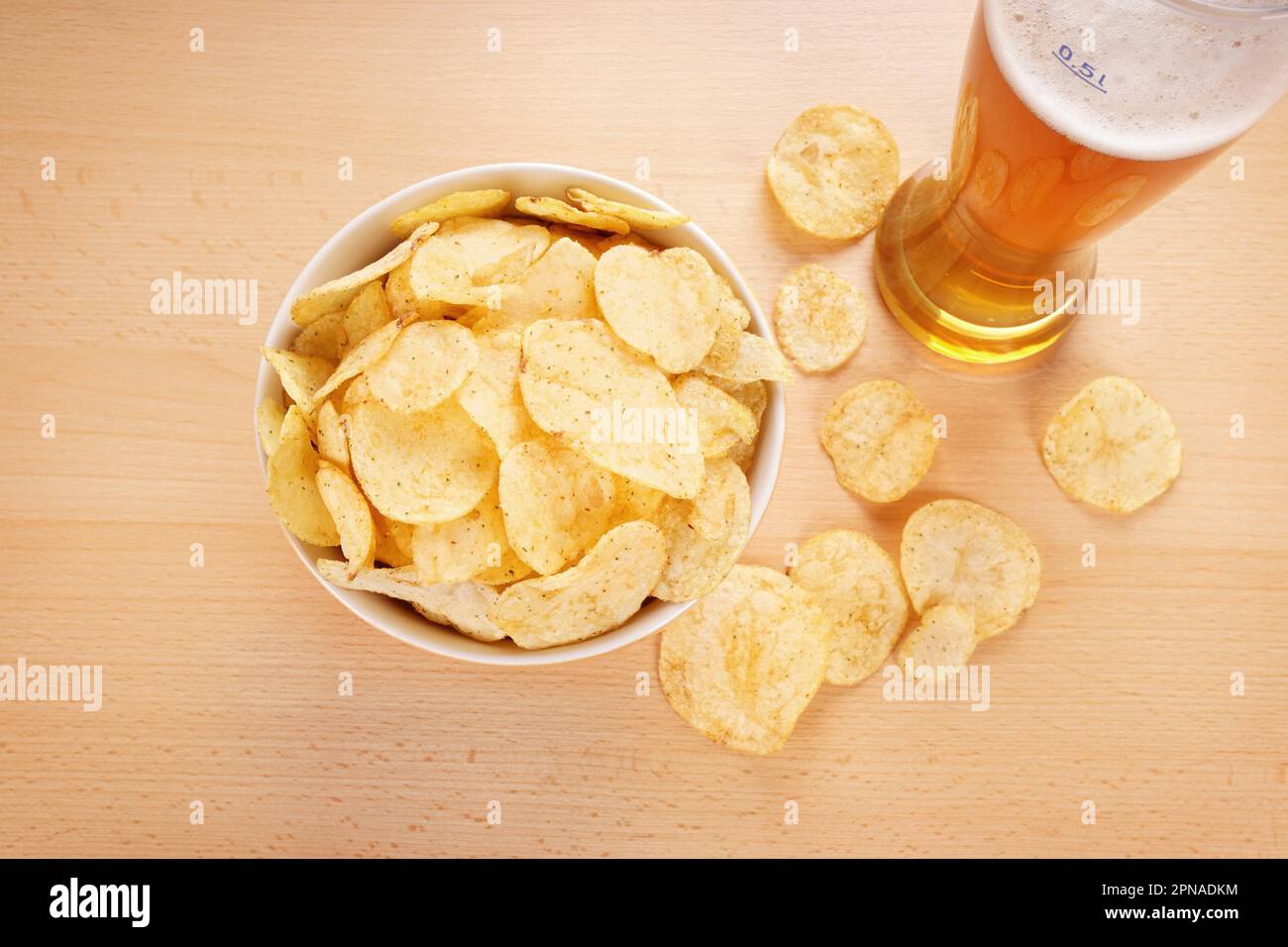 bowl of potato chips or crisps and a glass of wheat beer Stock Photo ...