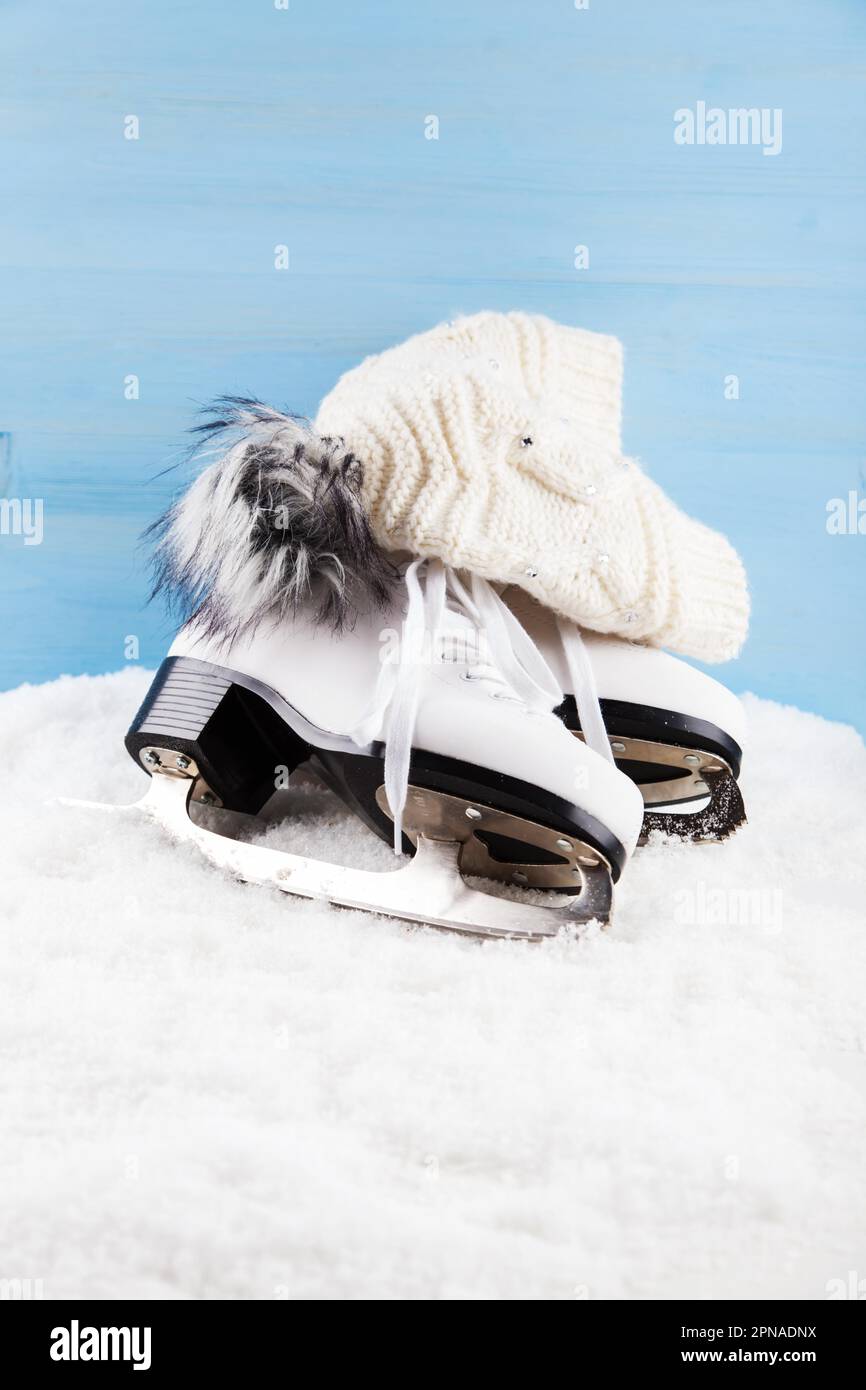 Ice skates with cap on the snow Stock Photo - Alamy