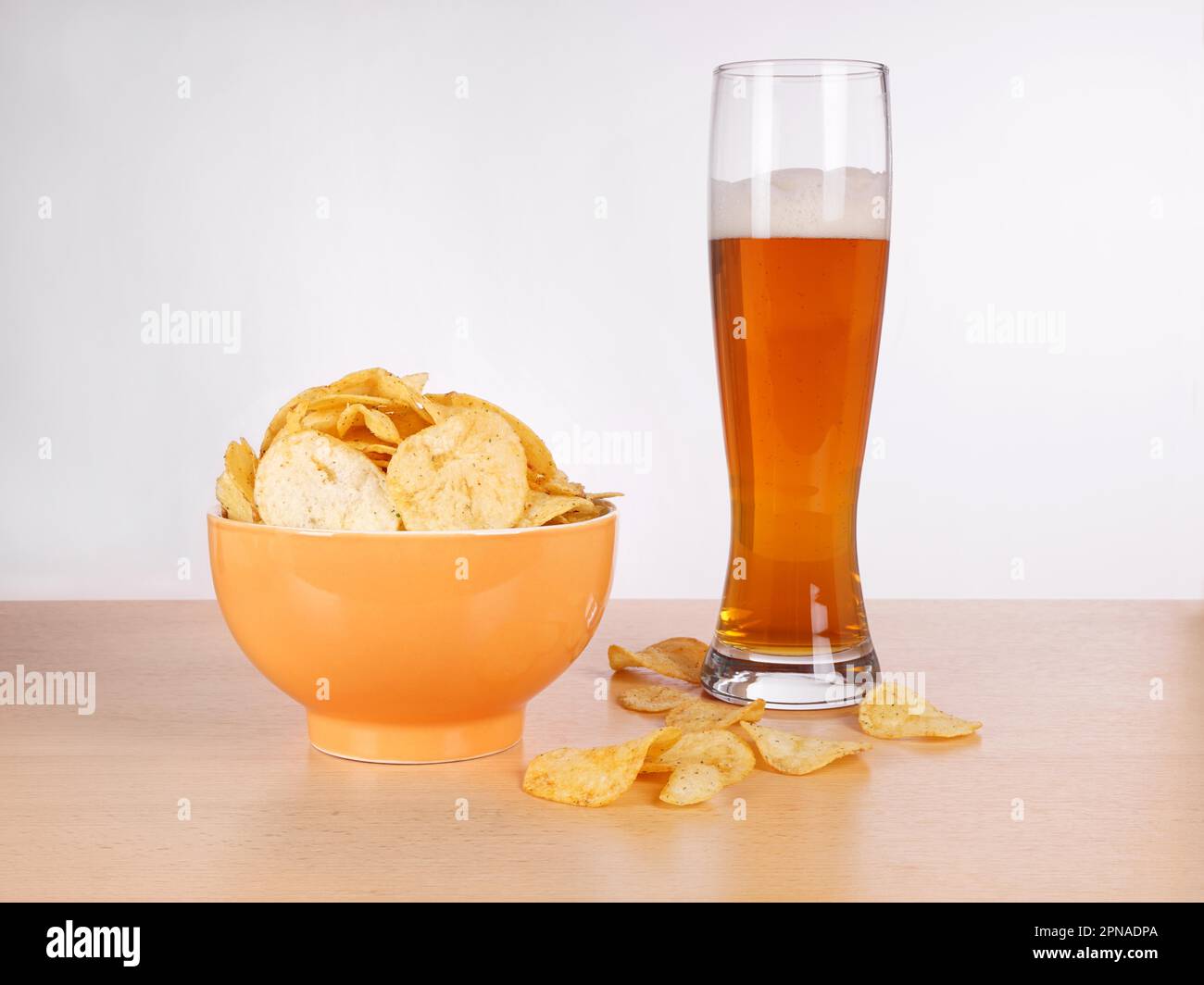 bowl of potato chips or crisps and a glass of wheat beer Stock Photo ...