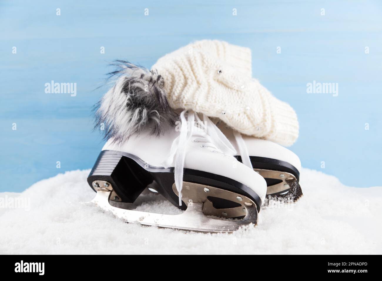 Ice skates with cap on the snow Stock Photo - Alamy