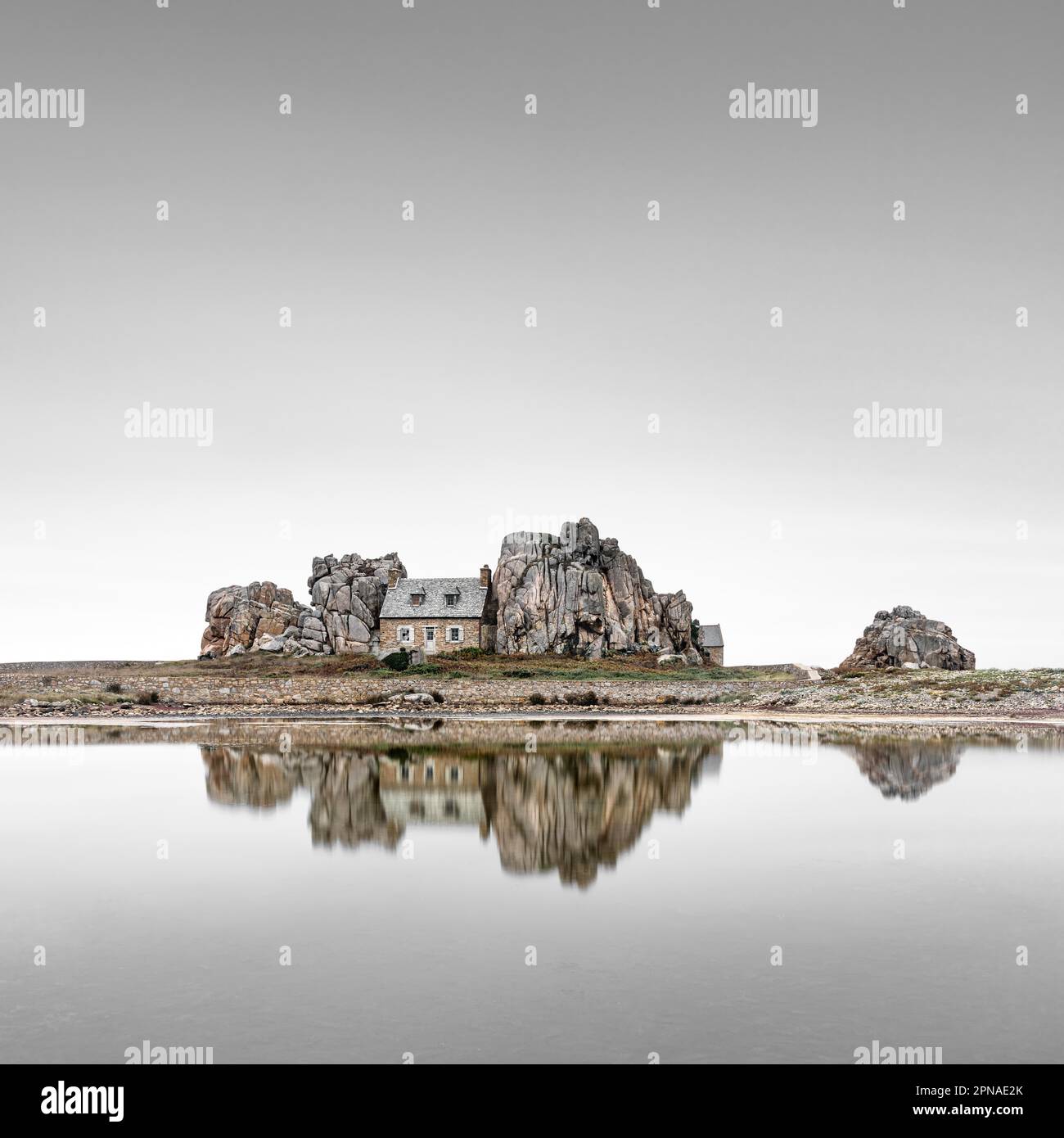 Reflection of an ancient and still inhabited stone house between two ...