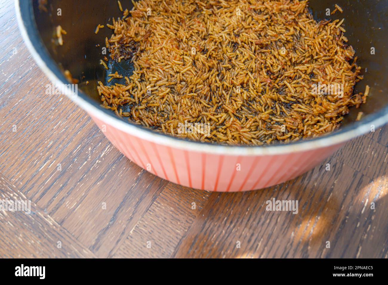 Burnt Nigerian smoky Jollof at the bottom of a pot Stock Photo - Alamy