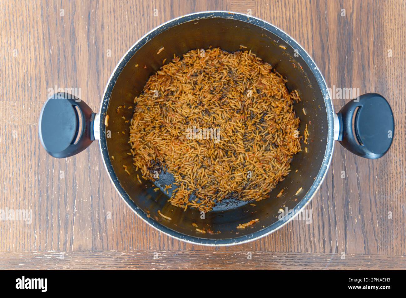 Burnt Nigerian smoky Jollof at the bottom of a pot Stock Photo - Alamy