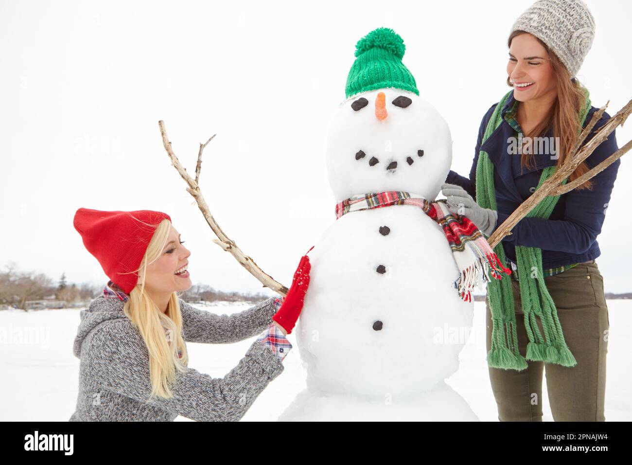 Do you wanna build a snowman. two friends building a snowman together ...