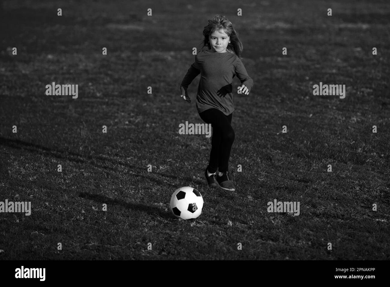 Young soccer player. Cute boy kicking soccer ball. School kids playing ...