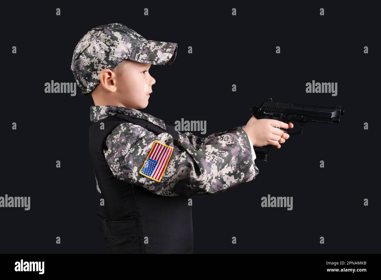Cute little soldier with gun on black background Stock Photo - Alamy