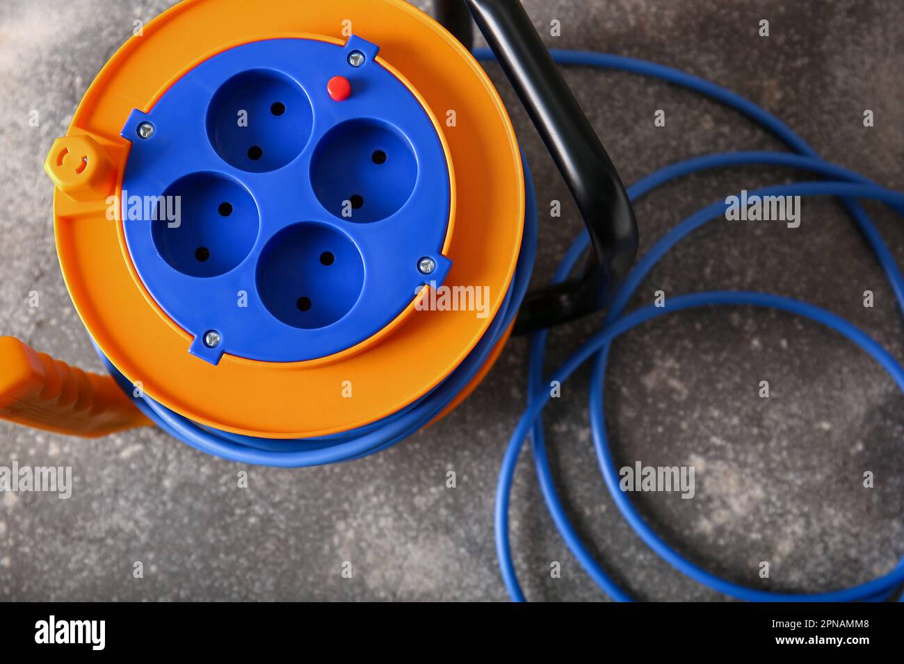 Extension electric cable reel on grunge background, closeup Stock Photo ...