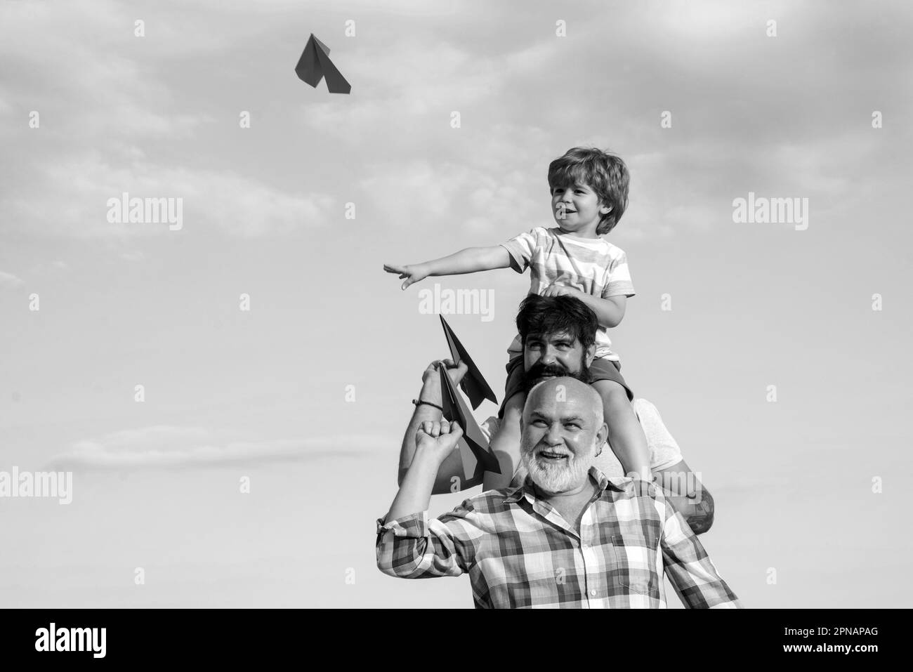 Happy man family have fun together. Kid pilot with toy jetpack against ...