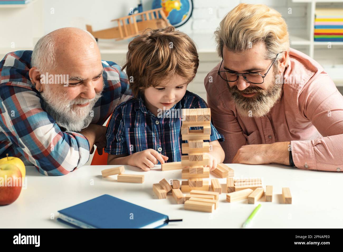 Boy pupil with father and grandfather. Three generations of men having ...