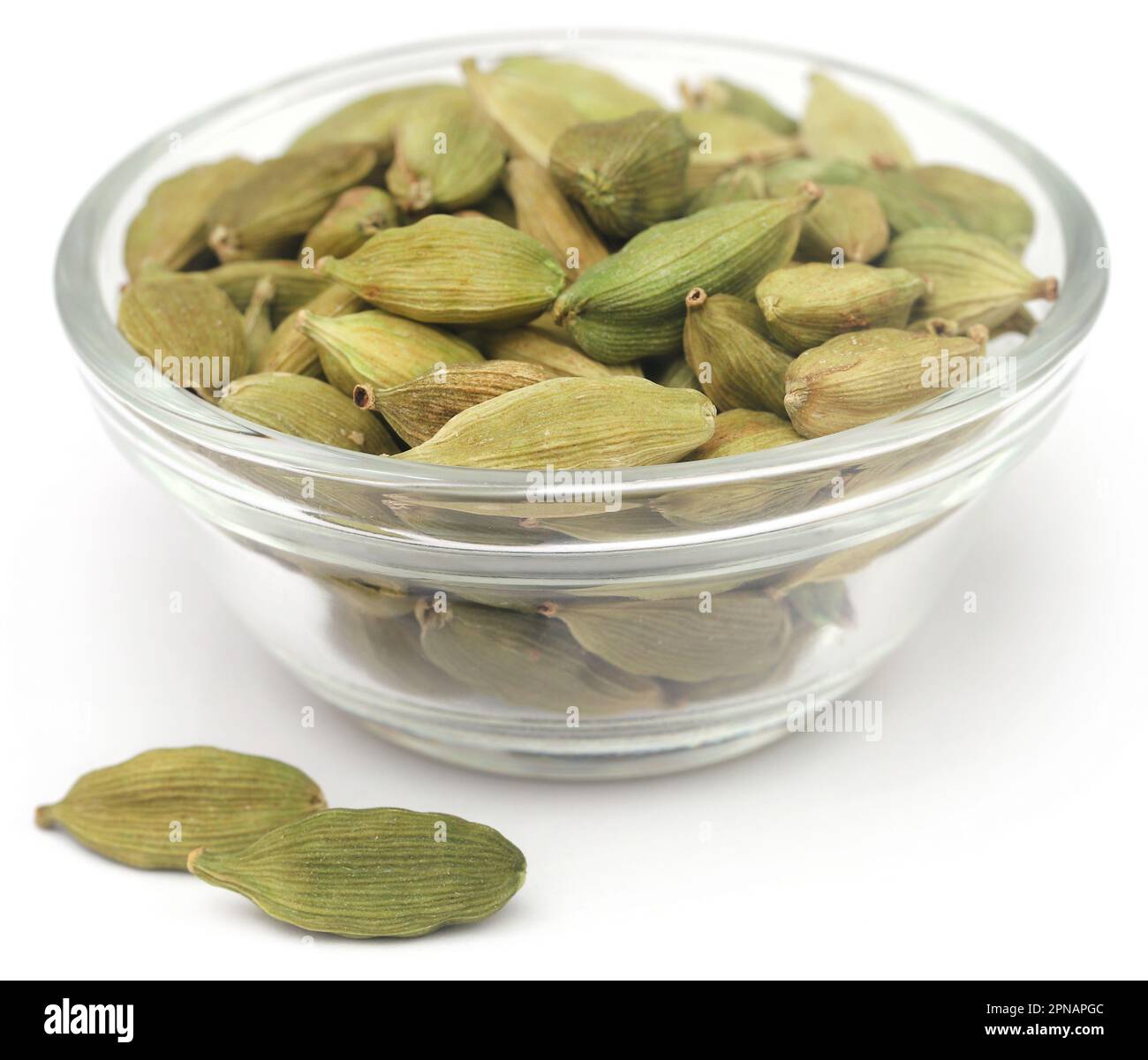 Fresh cardamom seeds in a bowl over white background Stock Photo - Alamy