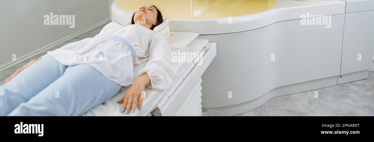 Woman patient is ready to do magnetic resonance imaging MRI or CT scan ...