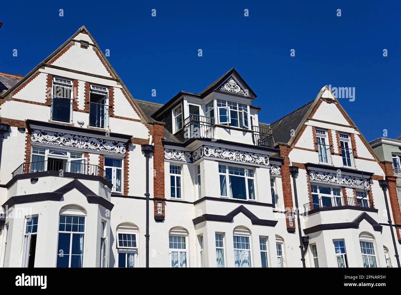 Traditional whitewashed building along the promenade, Sidmouth, Devon ...