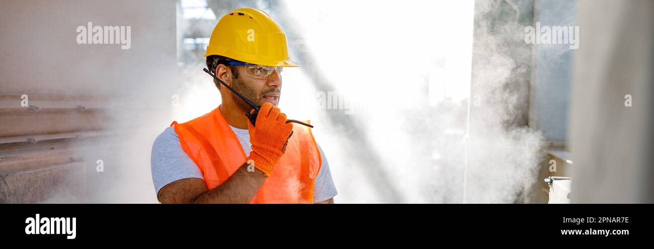Skillful multiethnic engineer working at construction plant Stock Photo ...