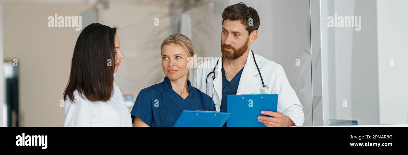 Group of doctor colleagues discussing patient diagnosis stand in clinic ...