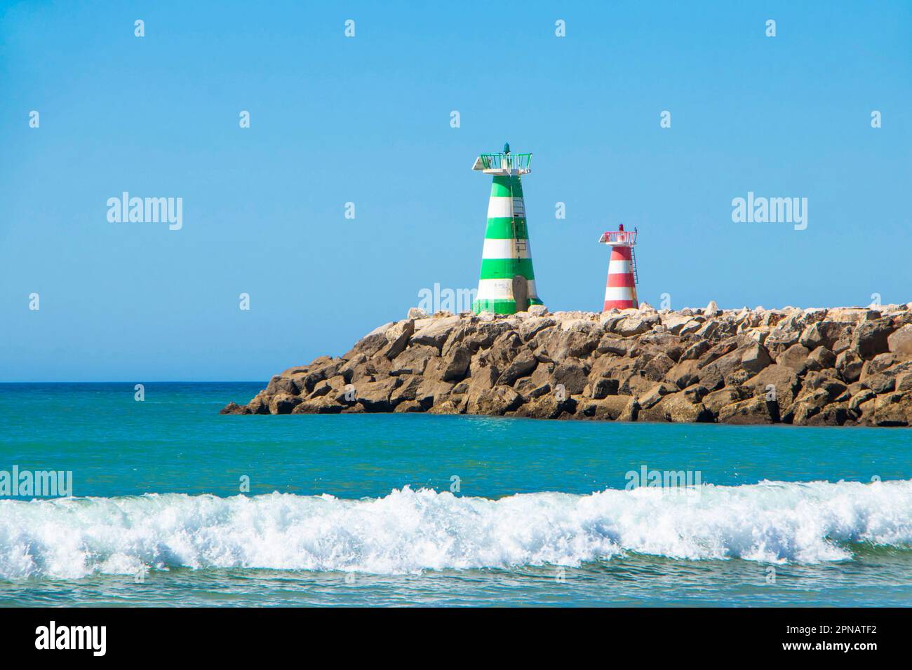 red and green warning beacons at entrance to harbour jetty in albufeira ...