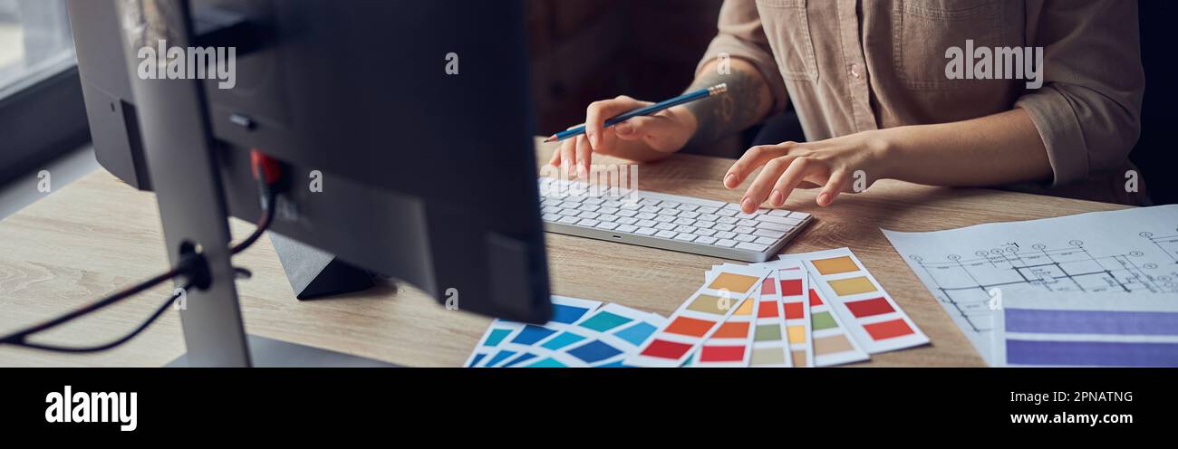 Female interior designer working on project of architecture drawing ...