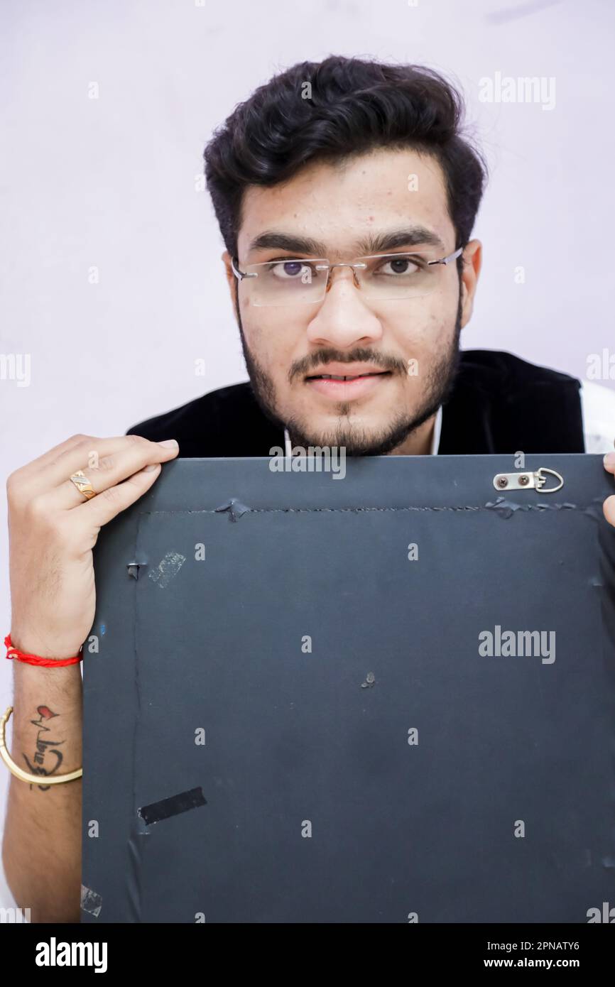 Indian yong smart student holding blank black bord in hands, smart ...