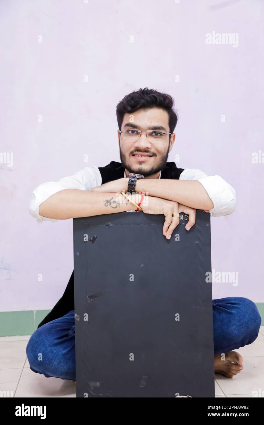 Indian yong smart student holding blank black bord in hands, smart ...