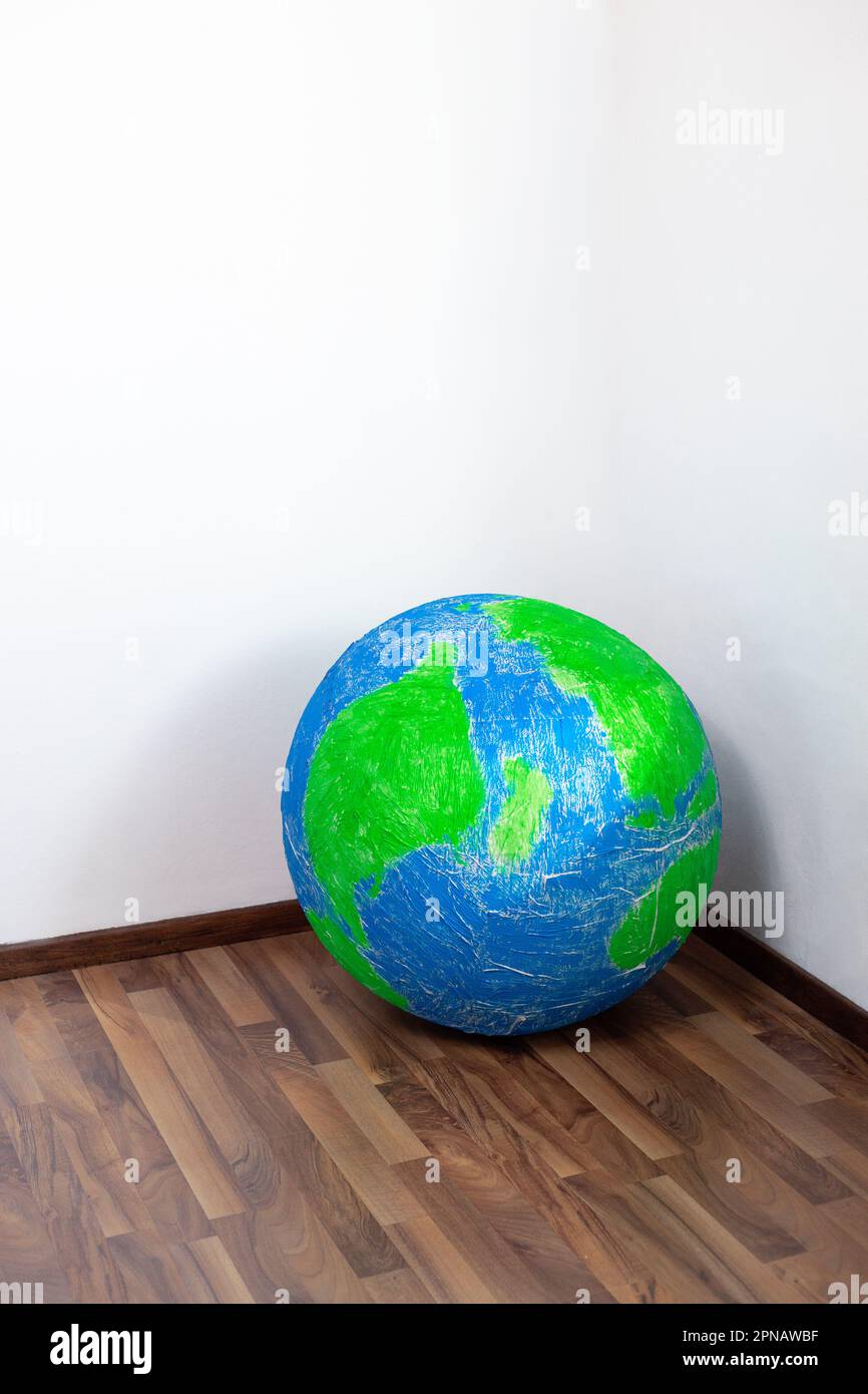 Eco problem. Planet earth in the corner of the room. Surrealism Stock ...